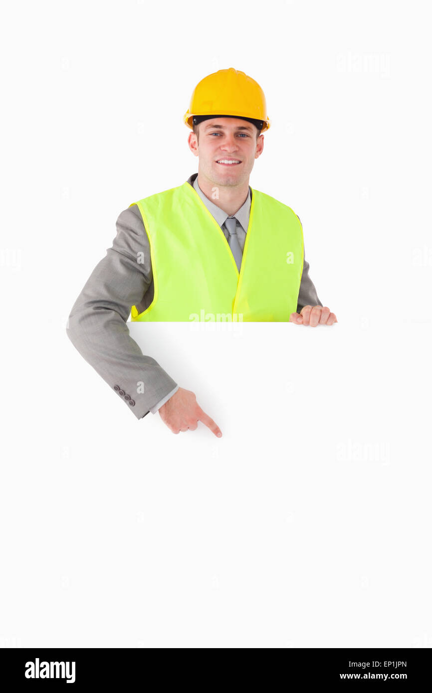 Portrait of a builder pointing at something Stock Photo - Alamy