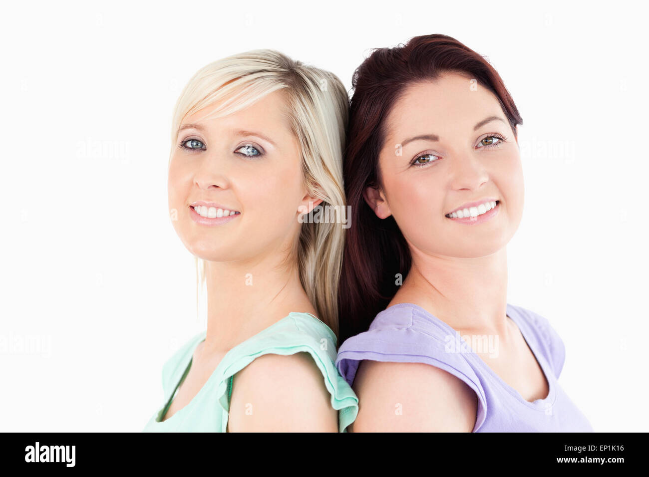 Cheerful Friends standing back to back Stock Photo - Alamy