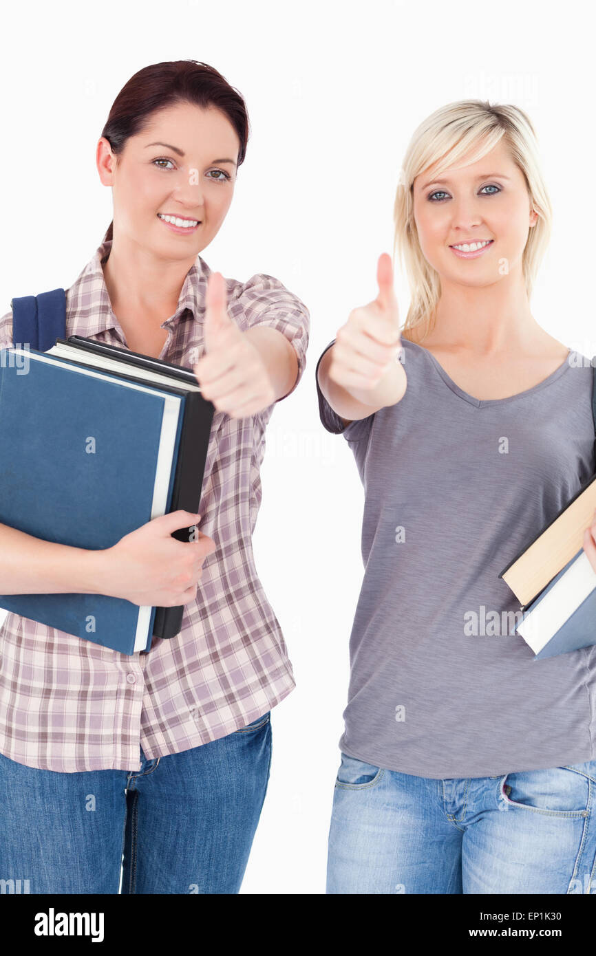 Students with books and thumbs up Stock Photo - Alamy