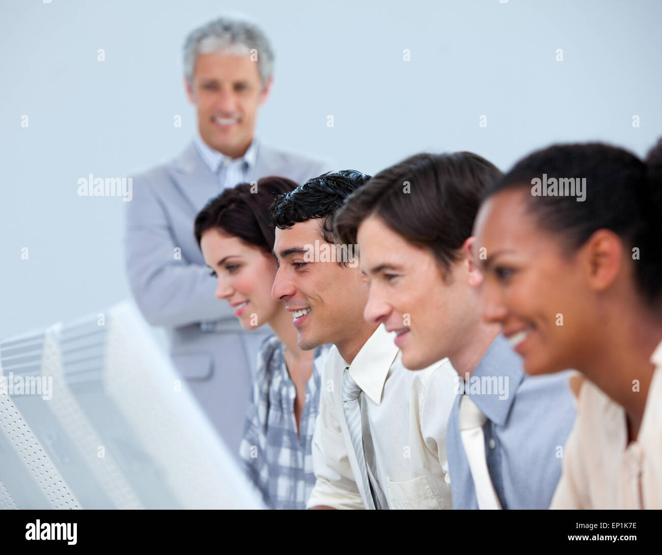 Positive business people with their senior manager Stock Photo - Alamy