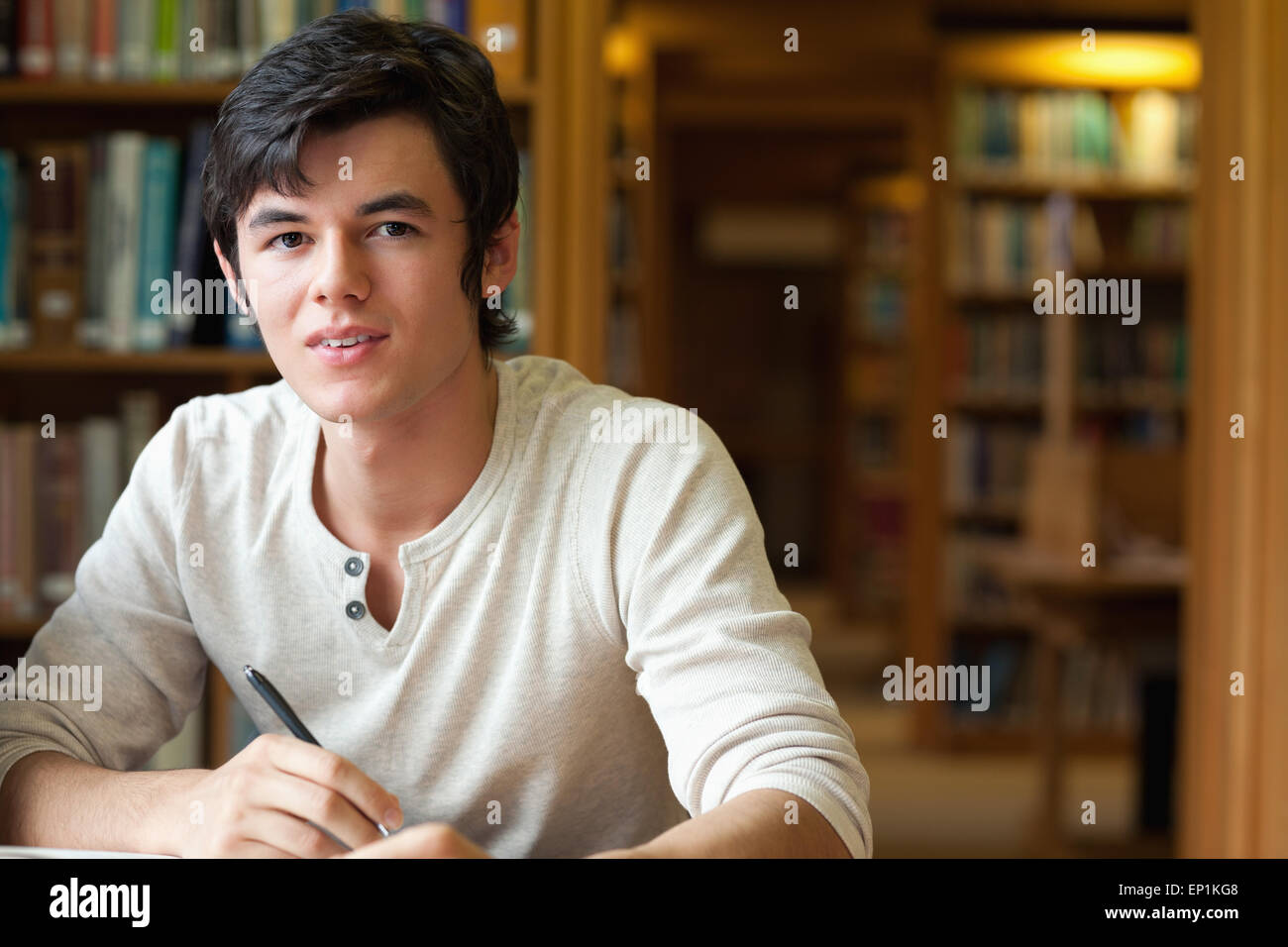 Student holding a pen Stock Photo - Alamy