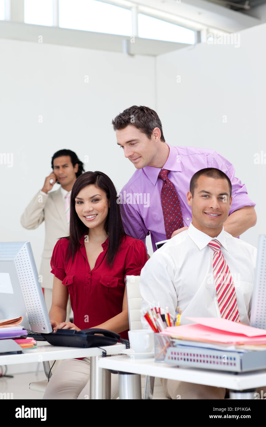 Smiling manager checking his team work Stock Photo - Alamy