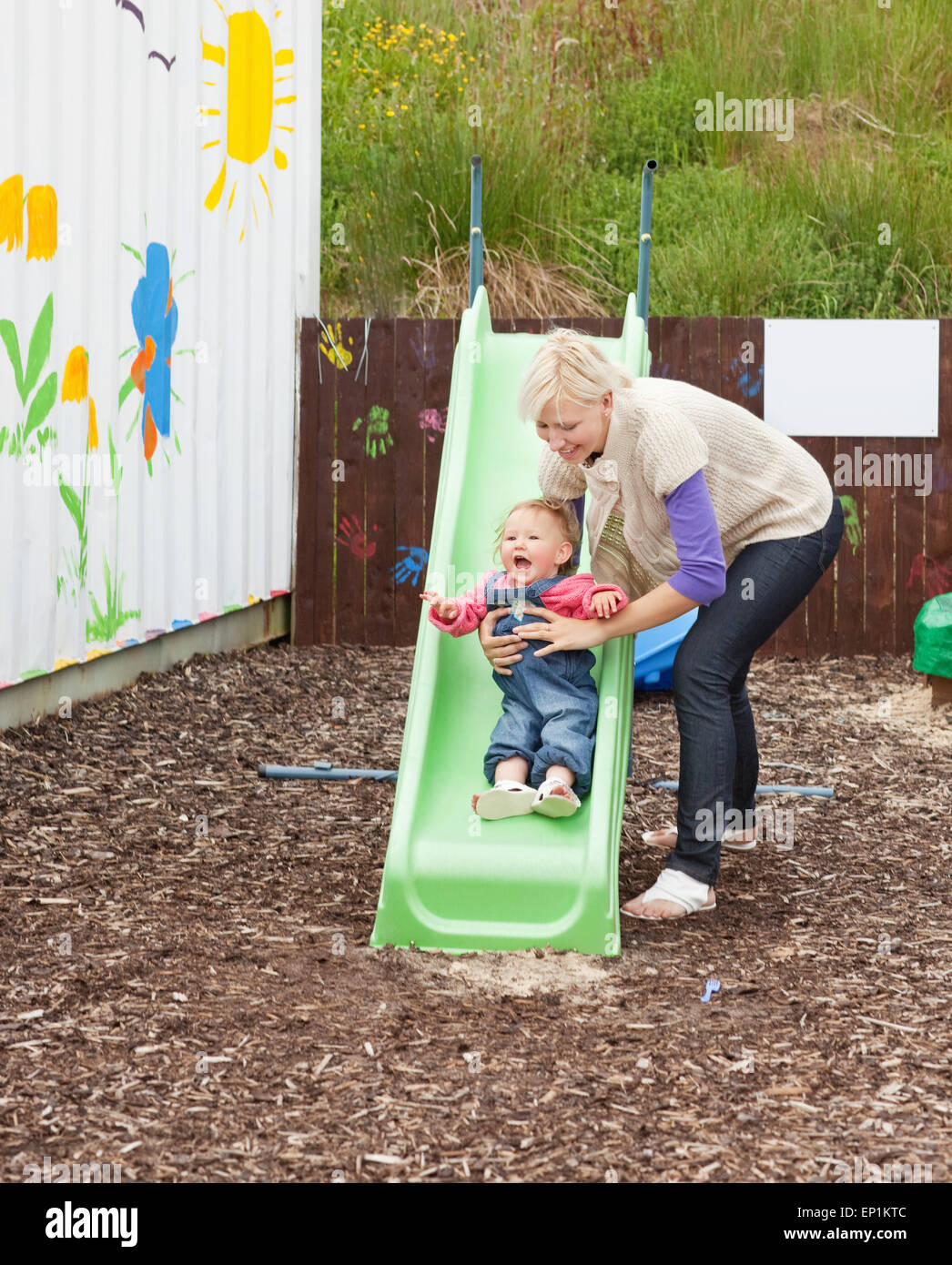 Young girl and her mother having fun with a chute Stock Photo - Alamy