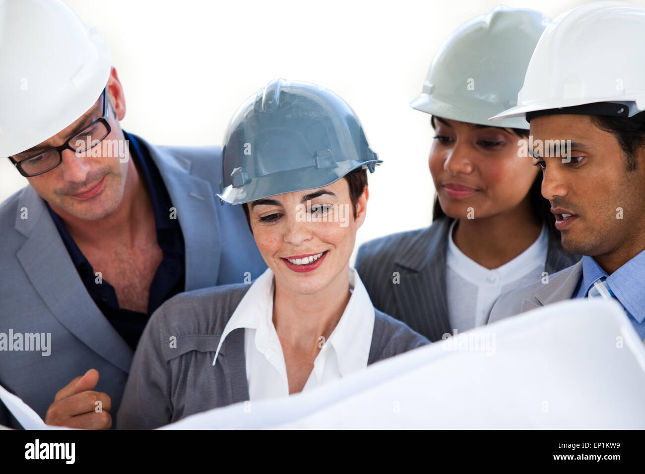 International architects studying a blueprint Stock Photo - Alamy