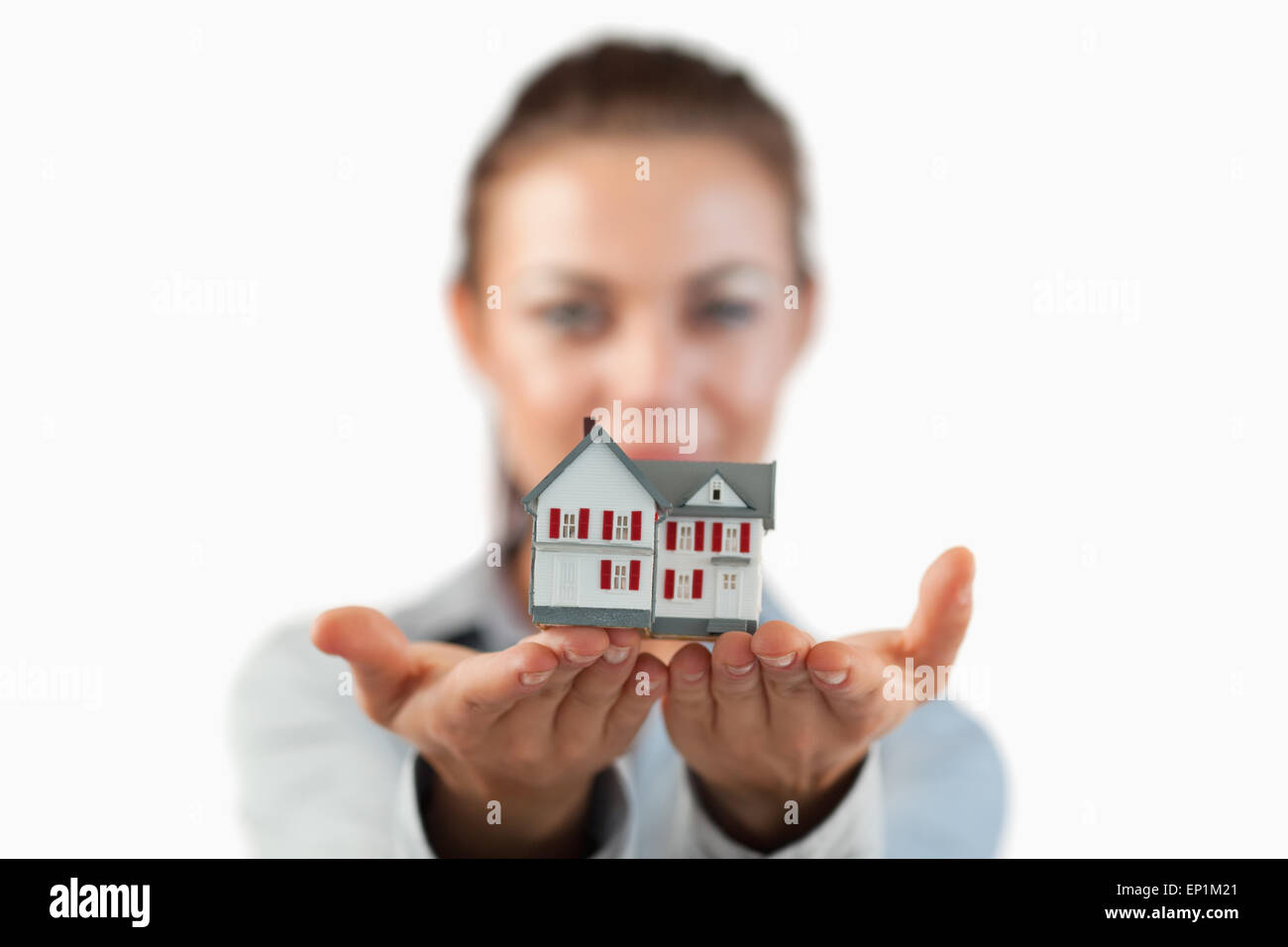 Miniature house being shown by female estate agent Stock Photo - Alamy
