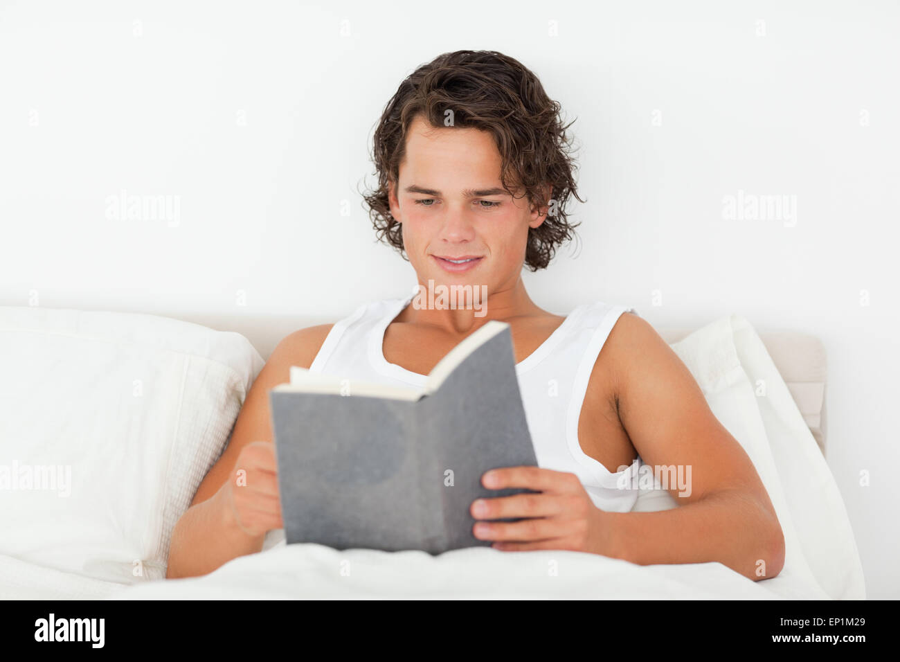 Handsome man reading a book Stock Photo - Alamy