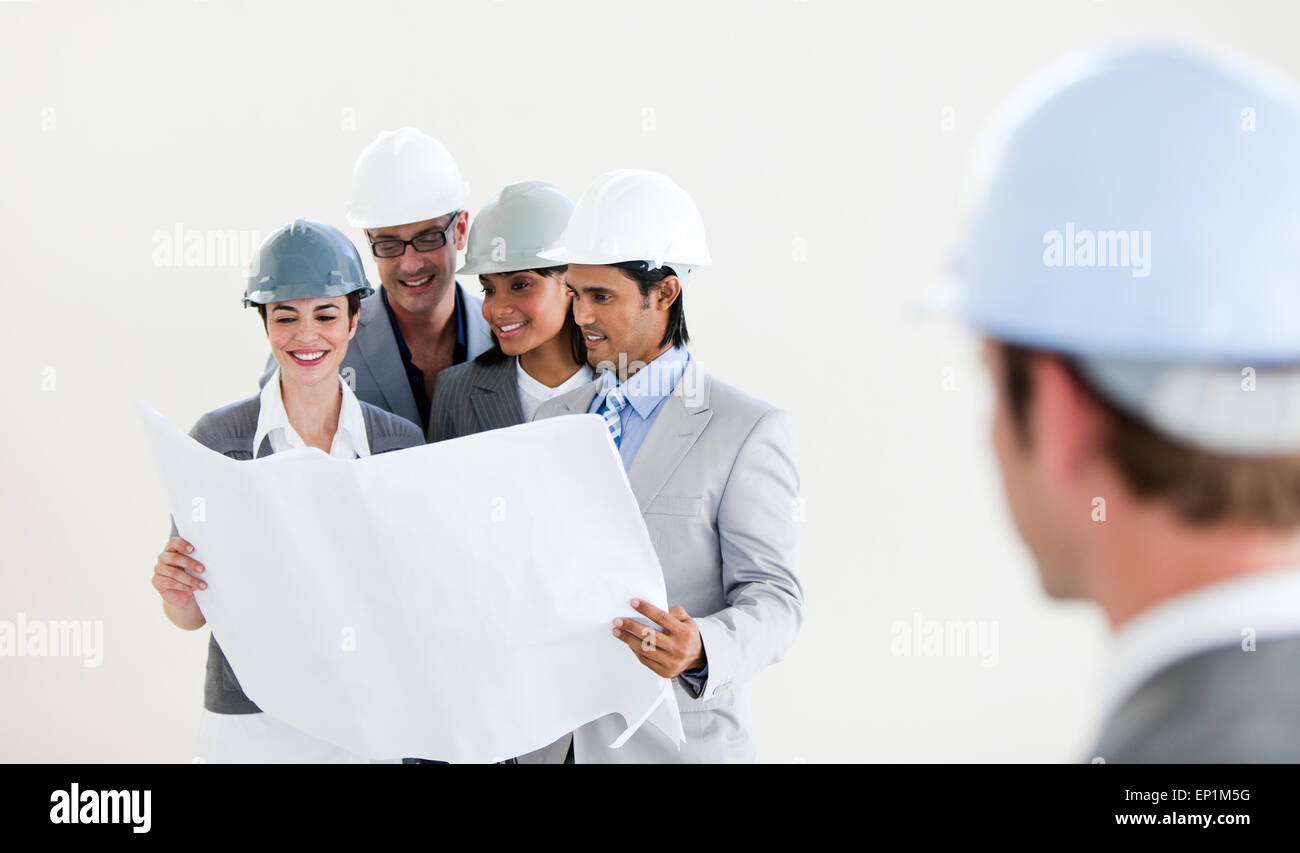 Male Engineer looking back at his smiling colleagues Stock Photo - Alamy
