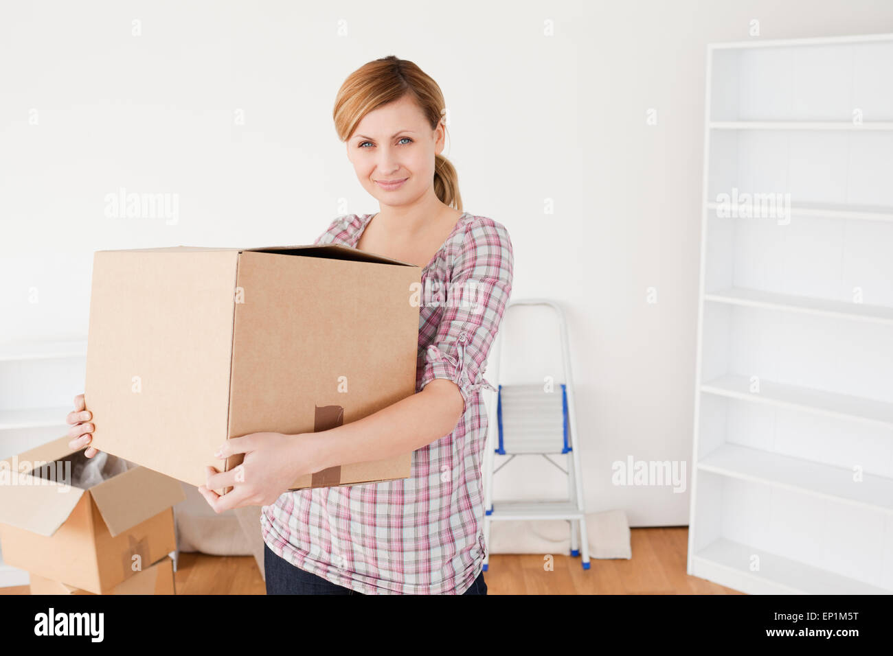 Attractive woman carrying cardboard boxes Stock Photo - Alamy