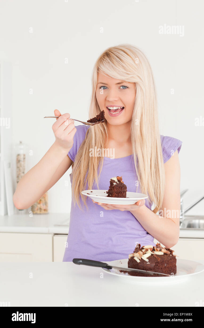 Beautiful caucasian female eating cake Stock Photo - Alamy