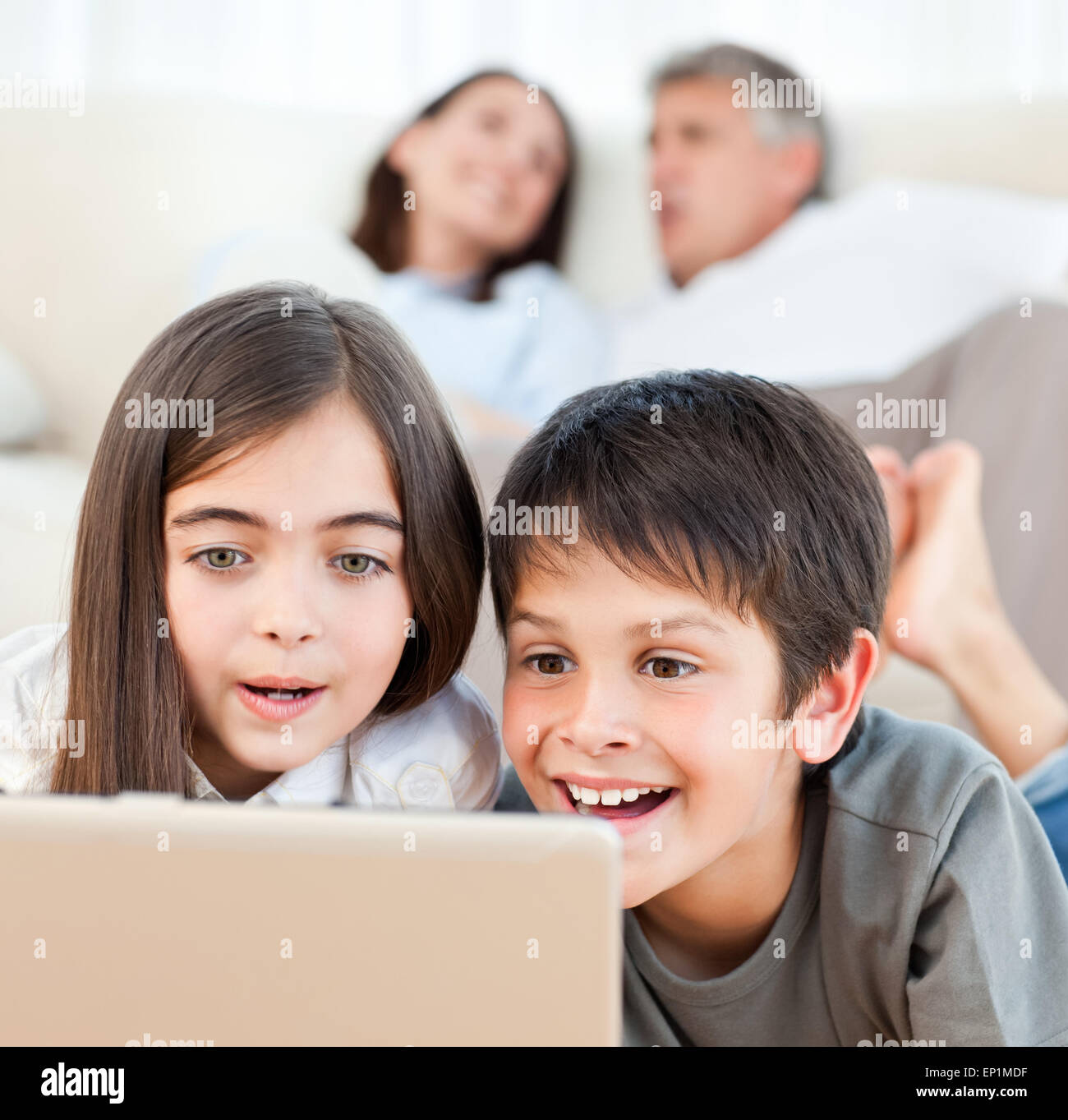 Lovely children watching a movie on their laptop at home Stock Photo ...