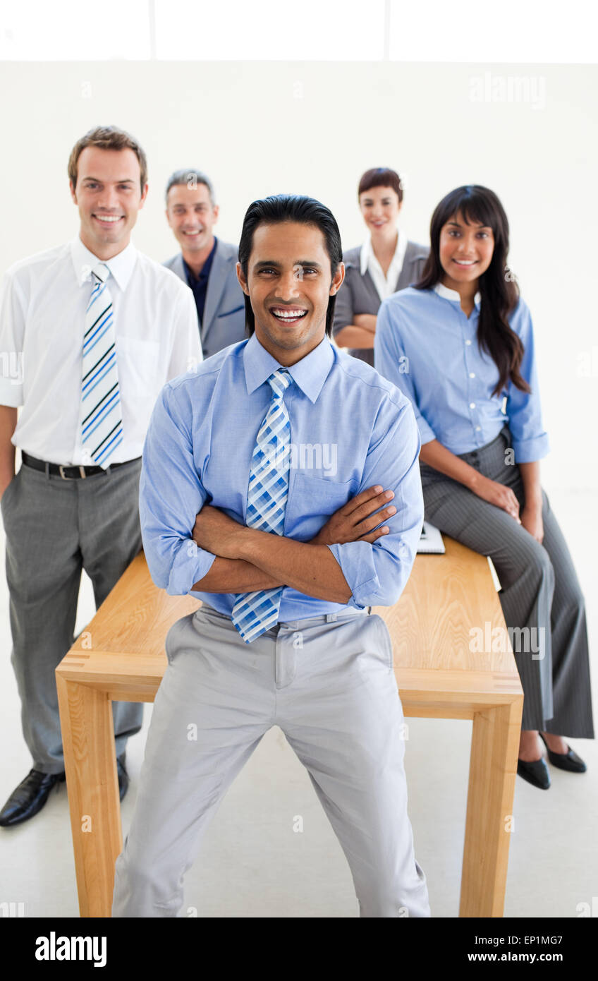Cheerful International Business partners standing around a table Stock ...