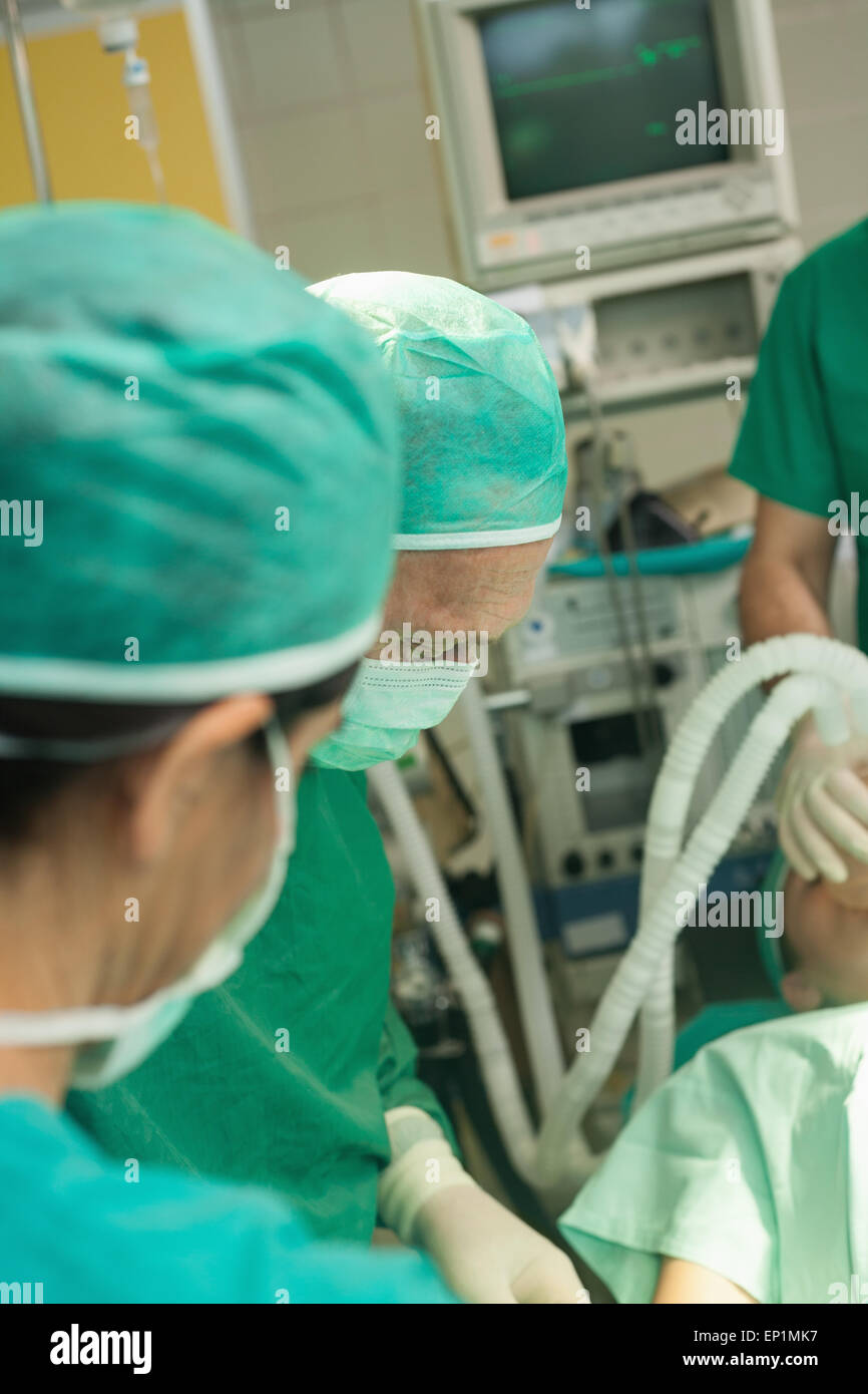 Surgeon and a team operating a sleeping patient Stock Photo - Alamy