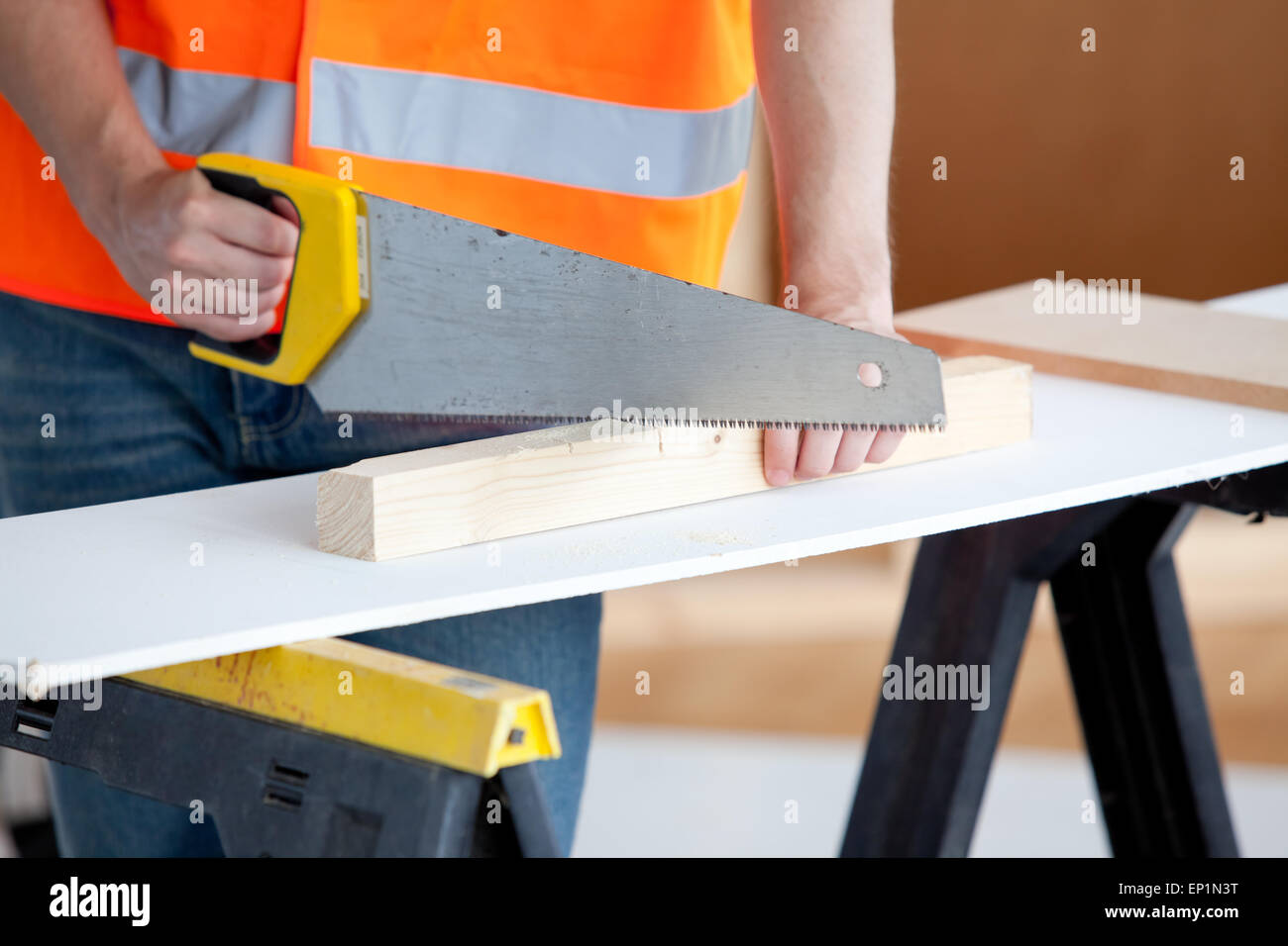 Close-up of a male worker sawing a wooden board Stock Photo - Alamy