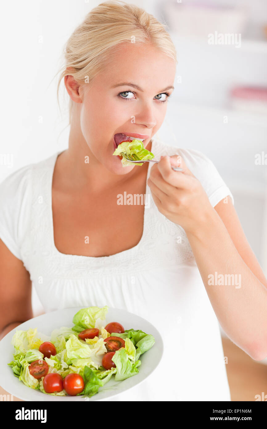 Portrait of a woman eating a salad Stock Photo - Alamy