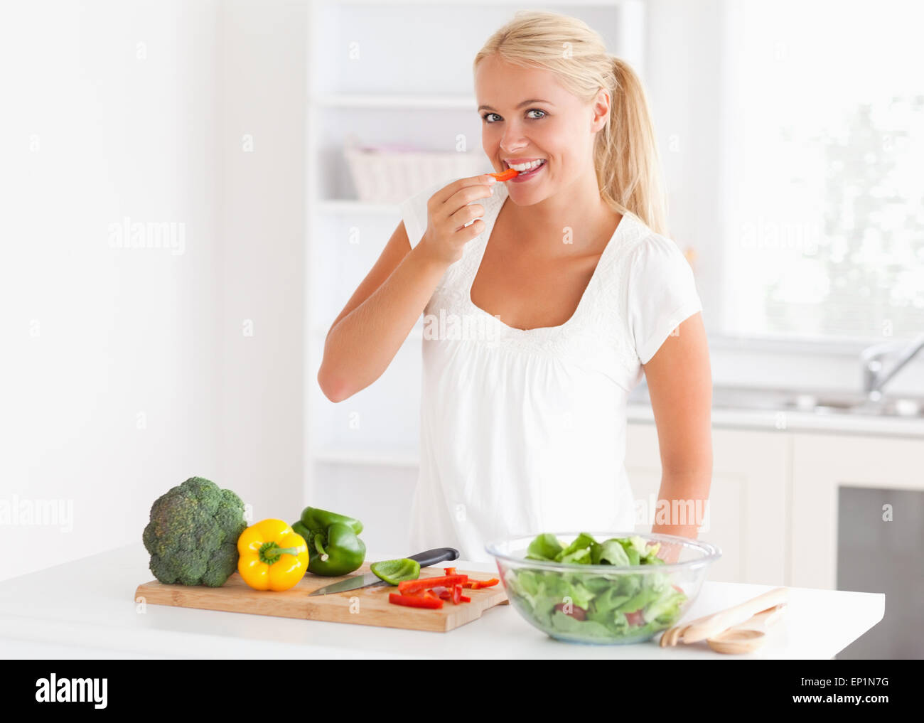 Woman eating pepper Stock Photo - Alamy
