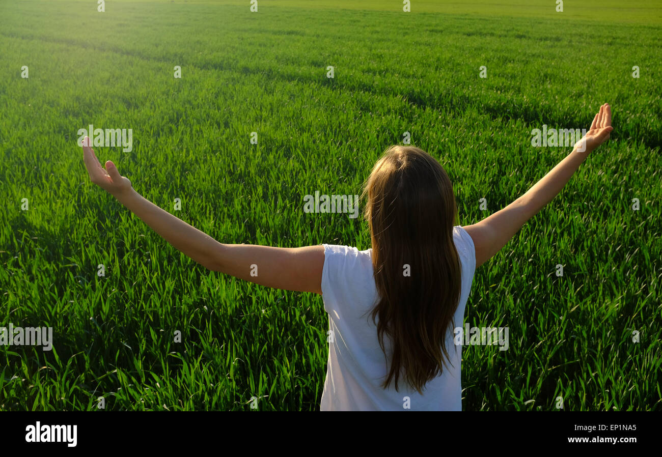 Girl spreading her arms towards the sky. Freedom gesture Stock Photo ...