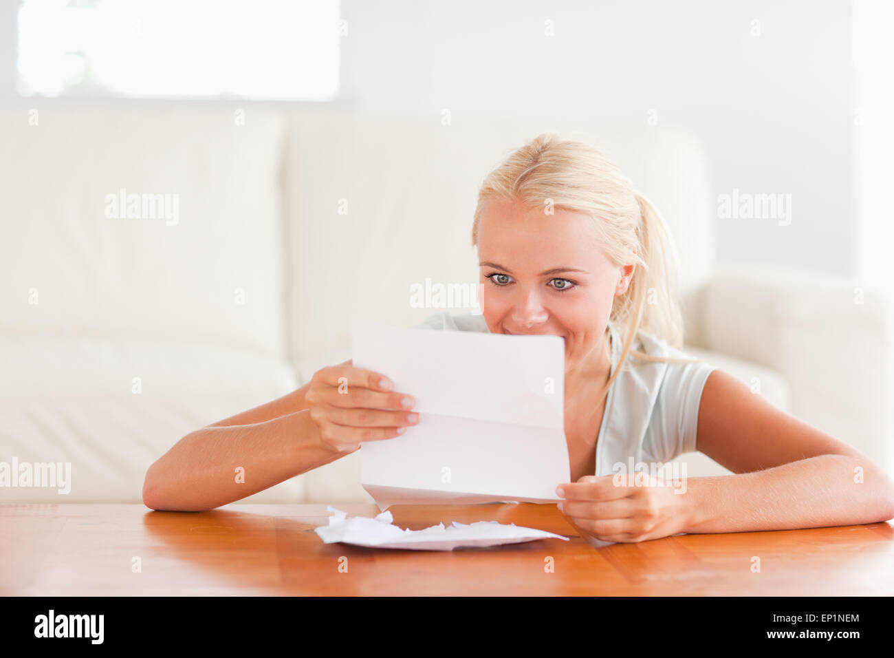 Happy woman reading a letter Stock Photo - Alamy