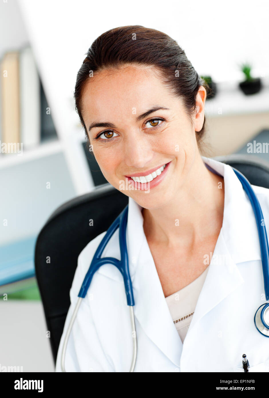 Self-assured female doctor smiling at the camera Stock Photo - Alamy
