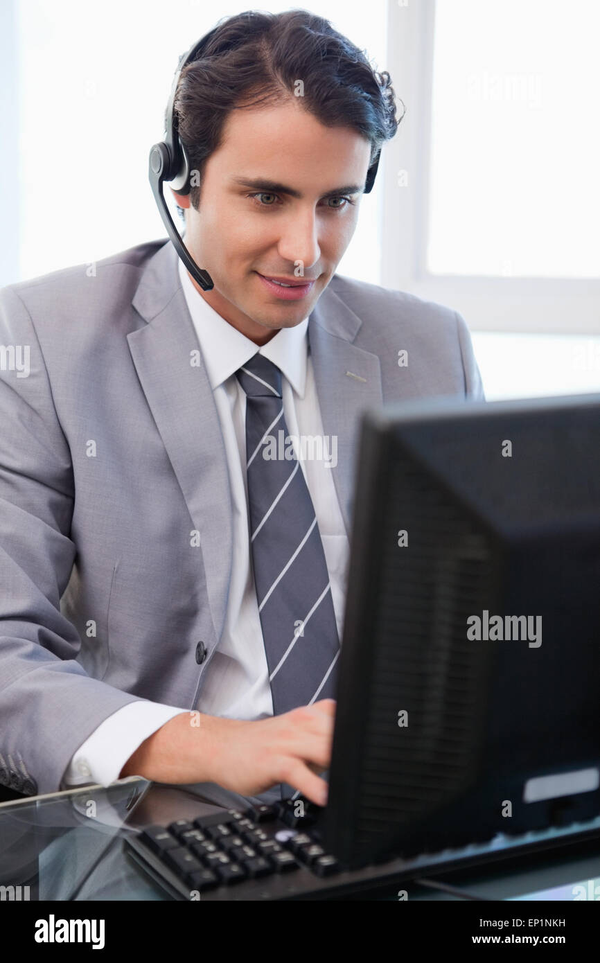 Portrait of a happy sales assistant working with a monitor Stock Photo ...