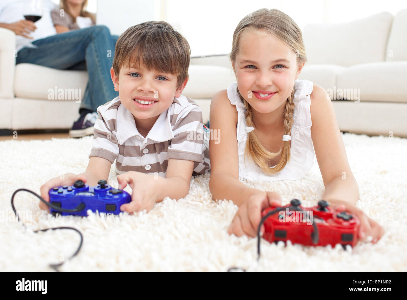 Cute brother and sister playing video games Stock Photo - Alamy