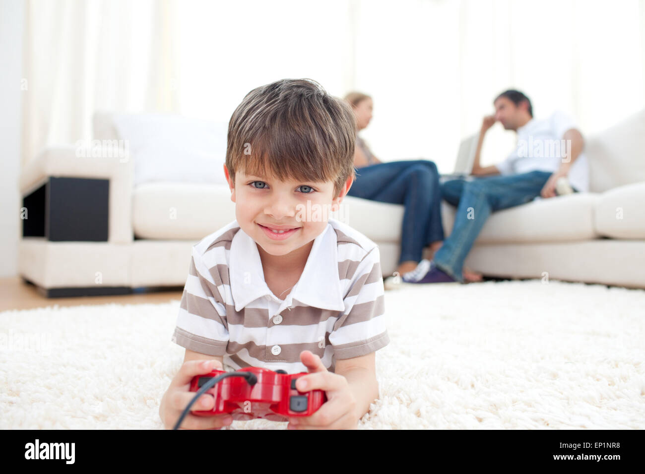 Adorable little boy playing video games Stock Photo - Alamy