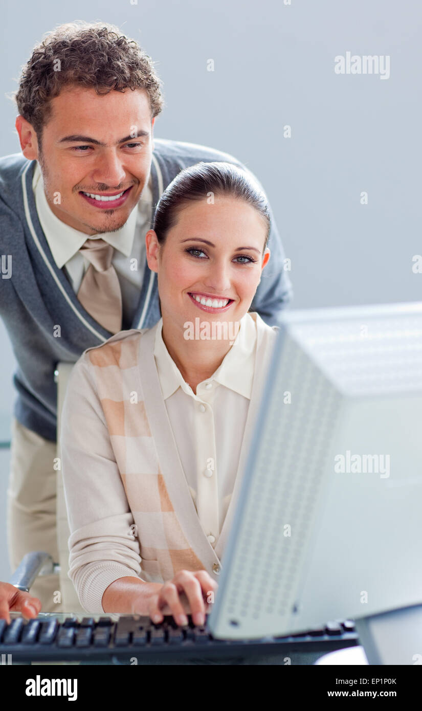 Attentive businessman helping his colleague work at a computer Stock ...