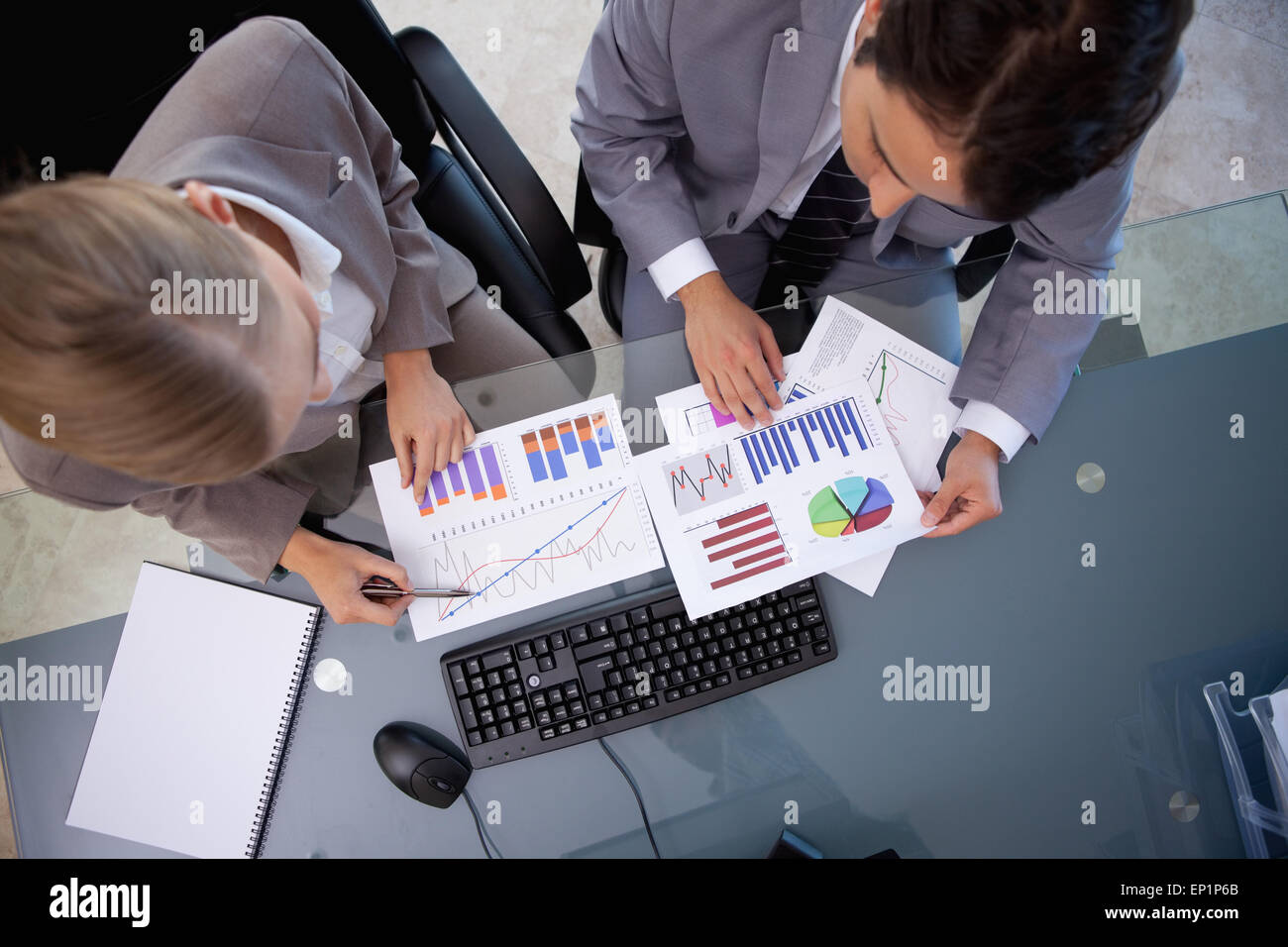 Business team looking at statistics Stock Photo - Alamy