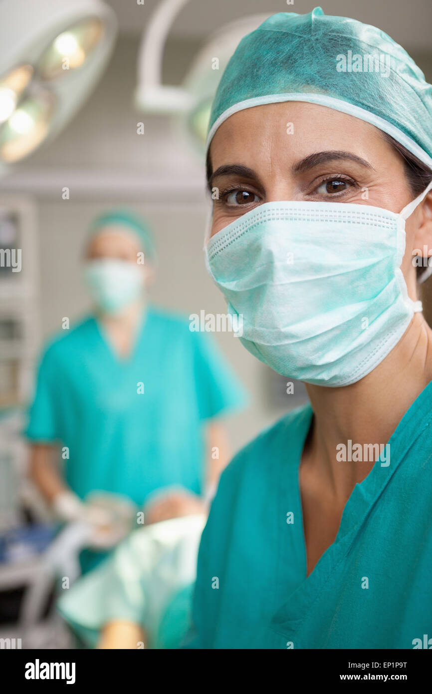Smiling surgeon standing in front of a colleague Stock Photo - Alamy