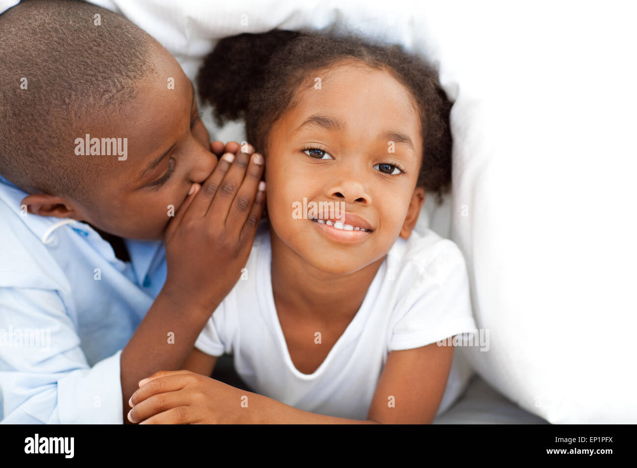 Adorable little boy whispering something to his sister Stock Photo - Alamy