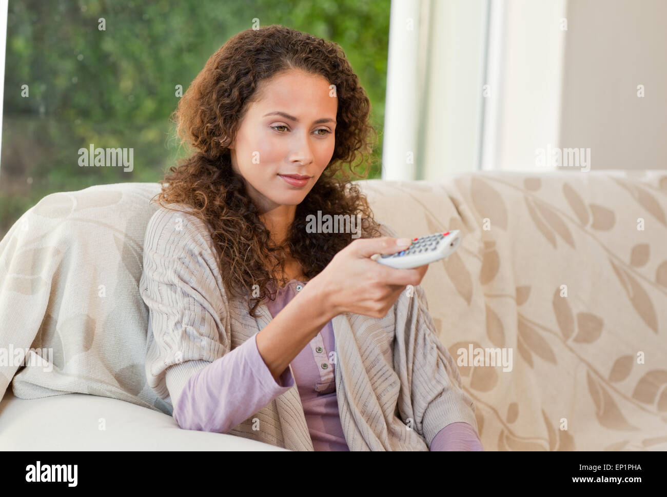 Woman with her remote Stock Photo - Alamy