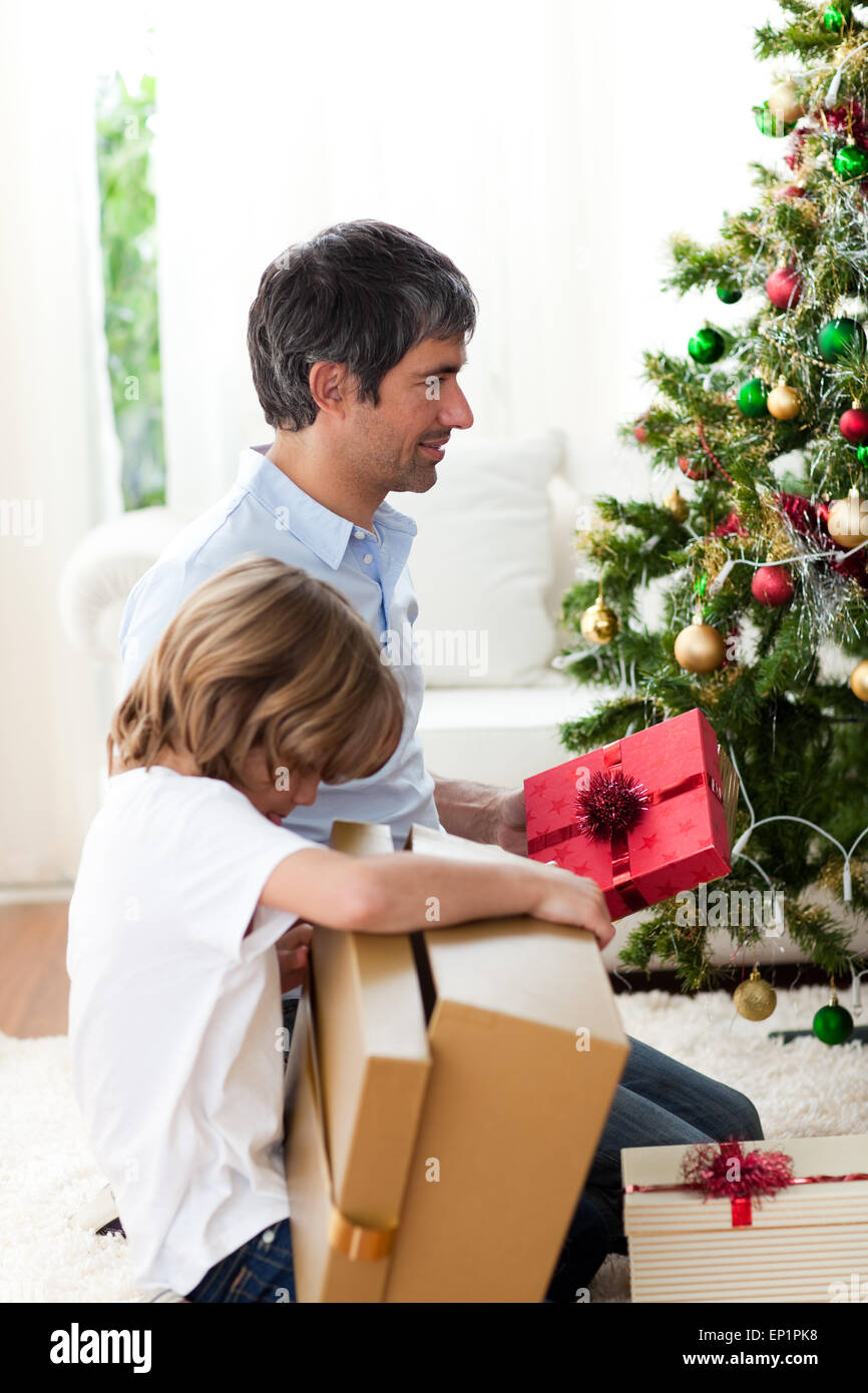 Father and his son opening Christmas gifts Stock Photo - Alamy