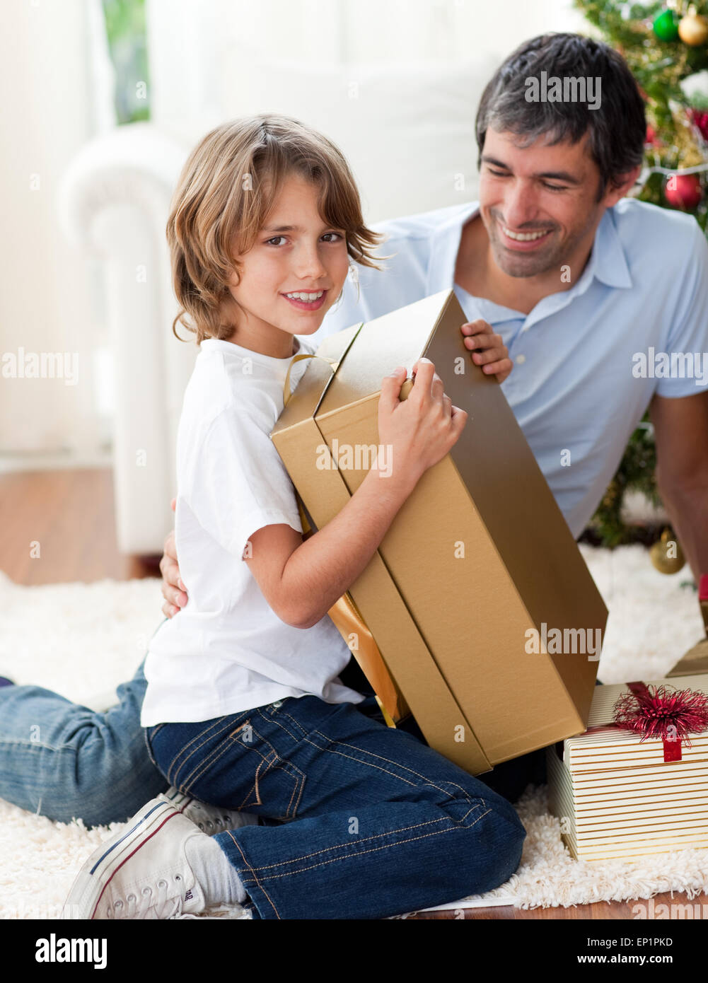 Happy Father and his son opening Christmas gifts Stock Photo - Alamy
