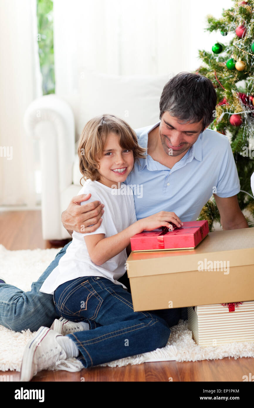 Little boy opening Christmas gifts with his father Stock Photo - Alamy