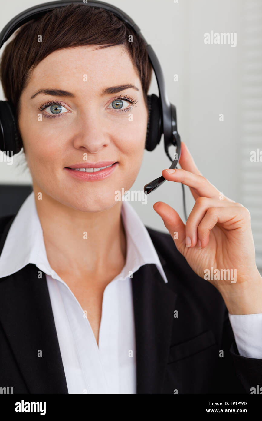 Portrait of a smiling secretary with a headset Stock Photo - Alamy