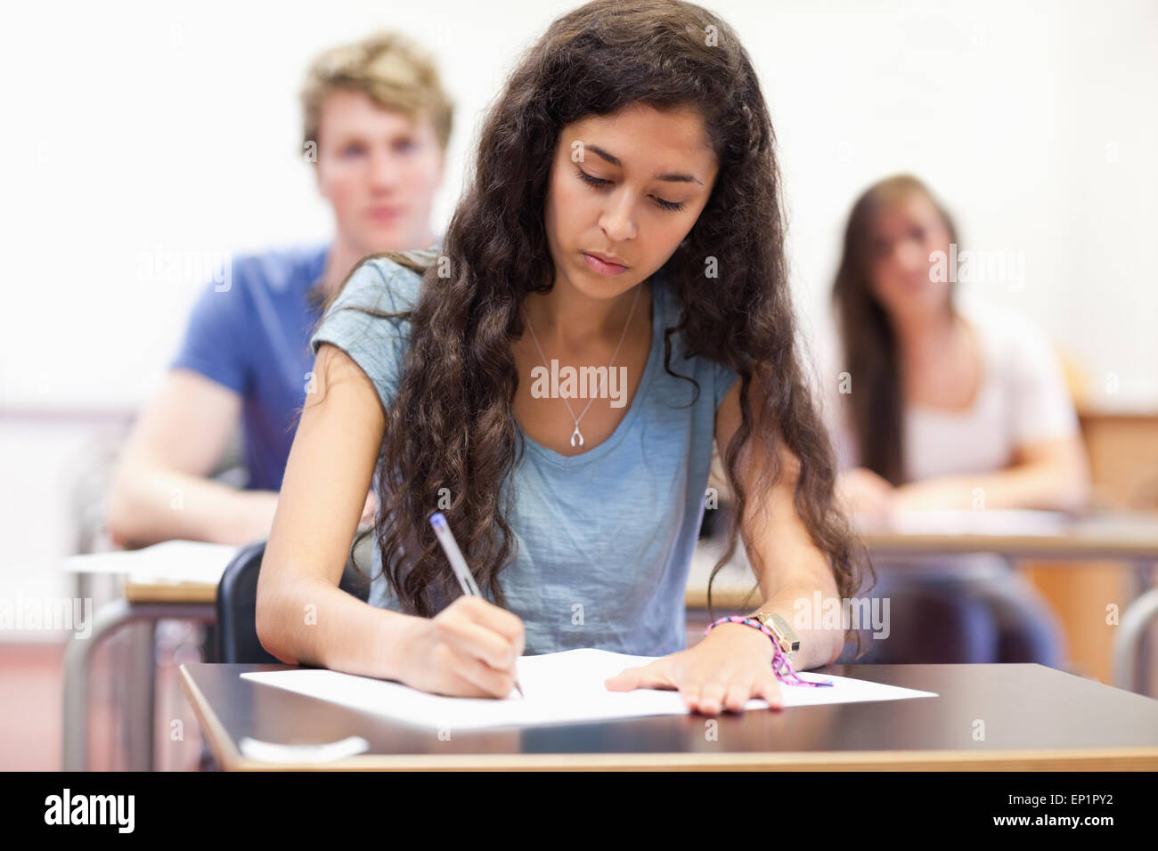 Students taking notes while their classmates are listening Stock Photo ...