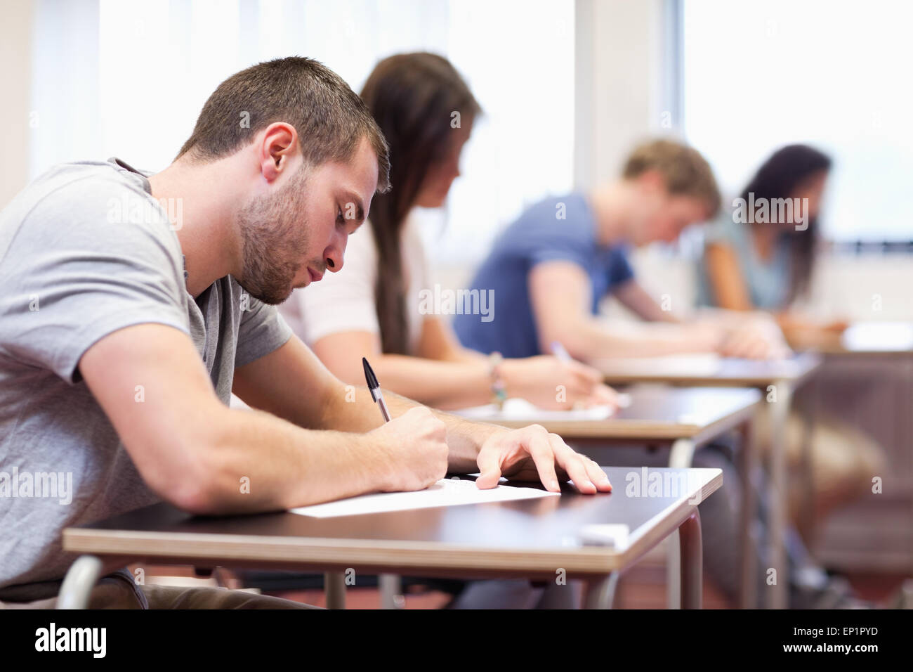 Handsome student writing an assignment Stock Photo - Alamy