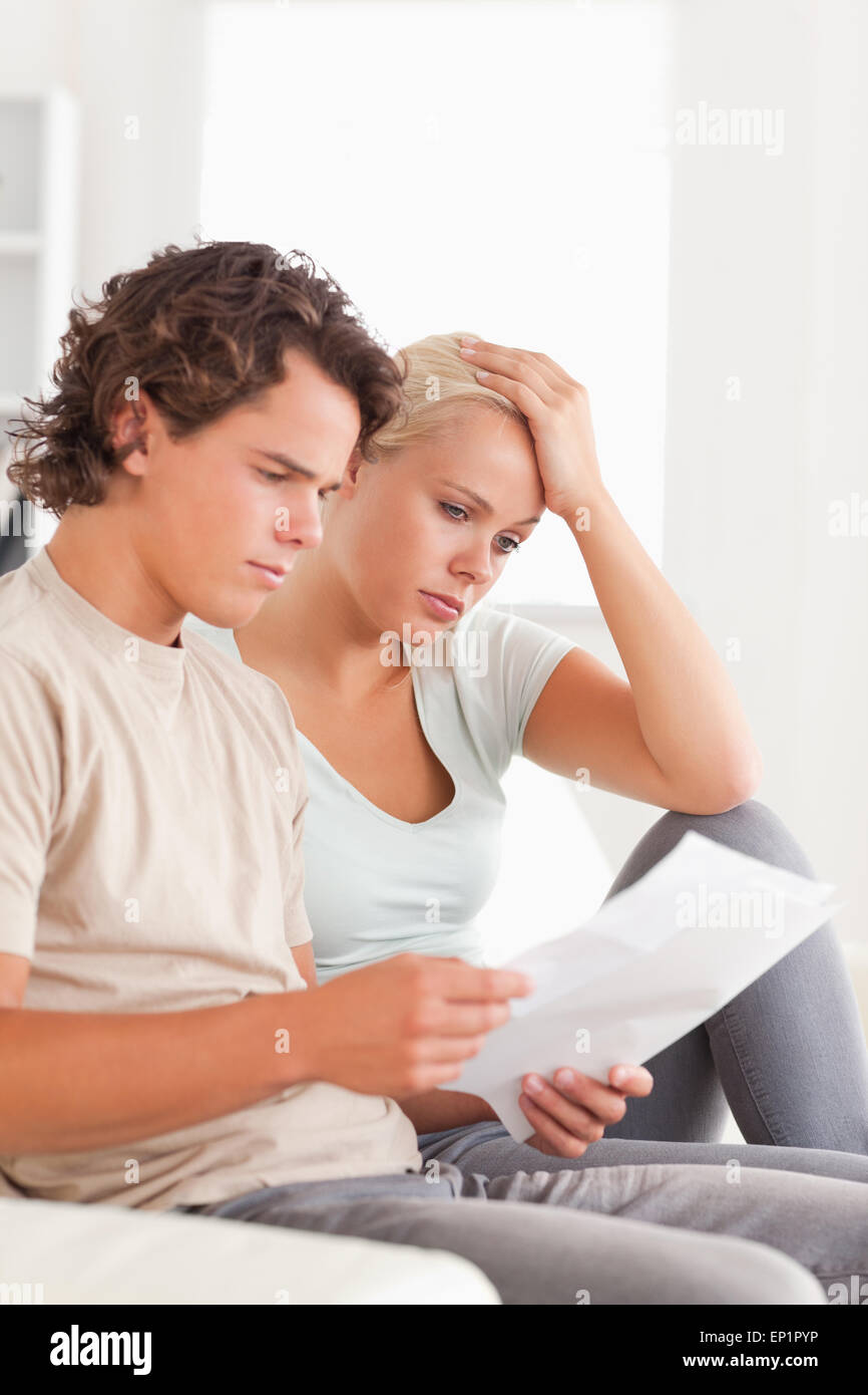 Shocked couple reading letters Stock Photo - Alamy