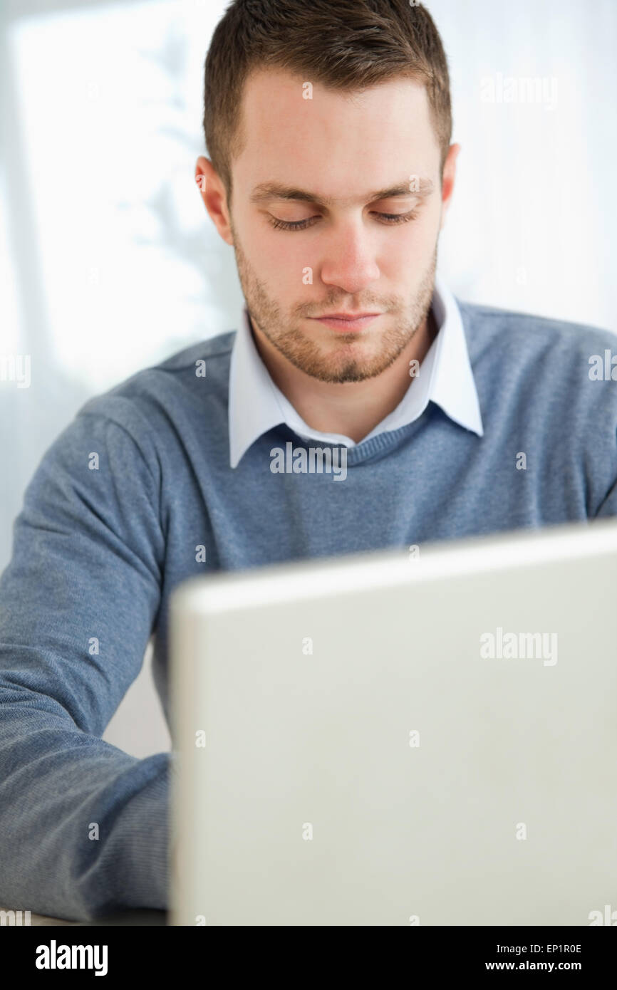 Young man typing on laptop Stock Photo - Alamy