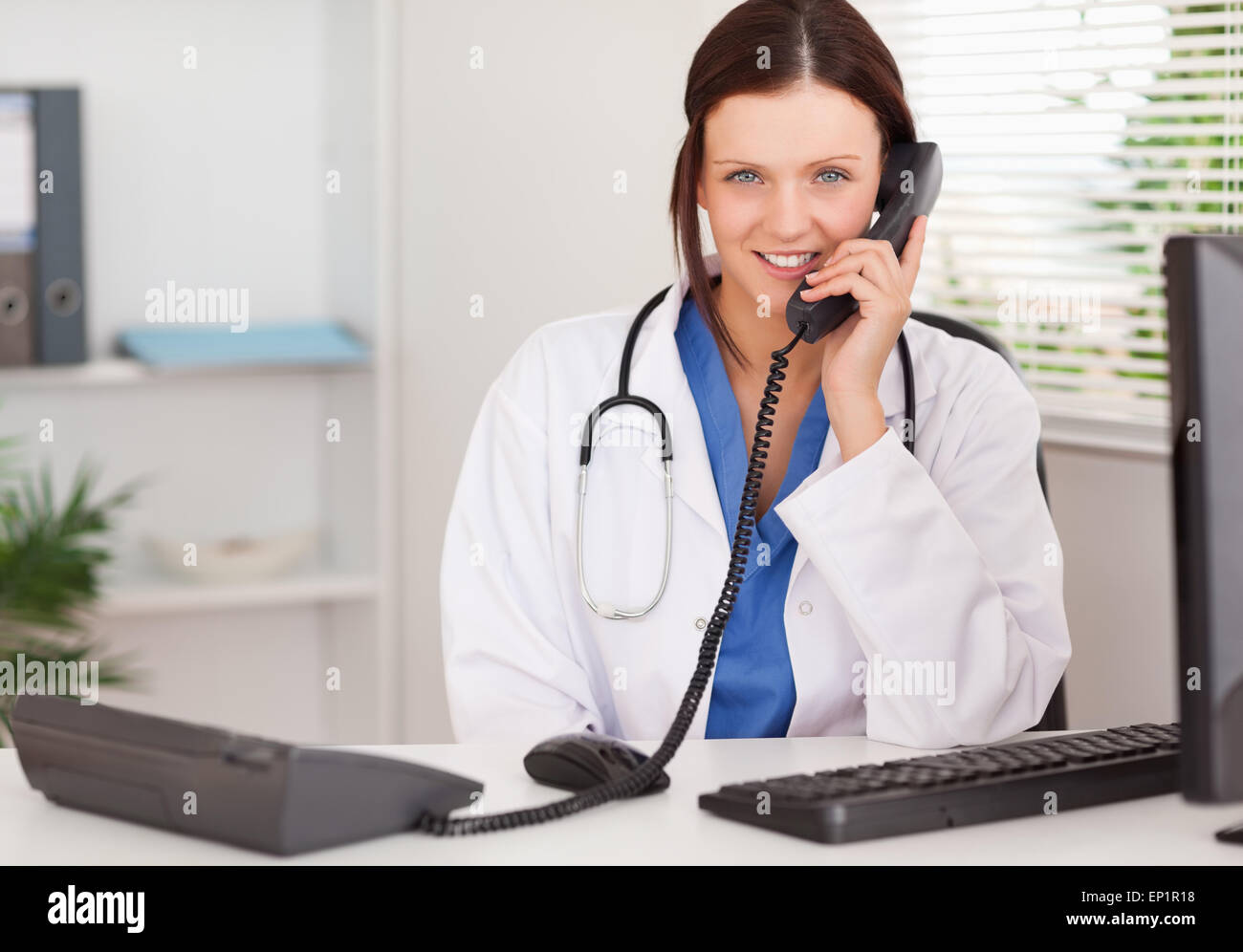 Female doctor telephoning Stock Photo - Alamy