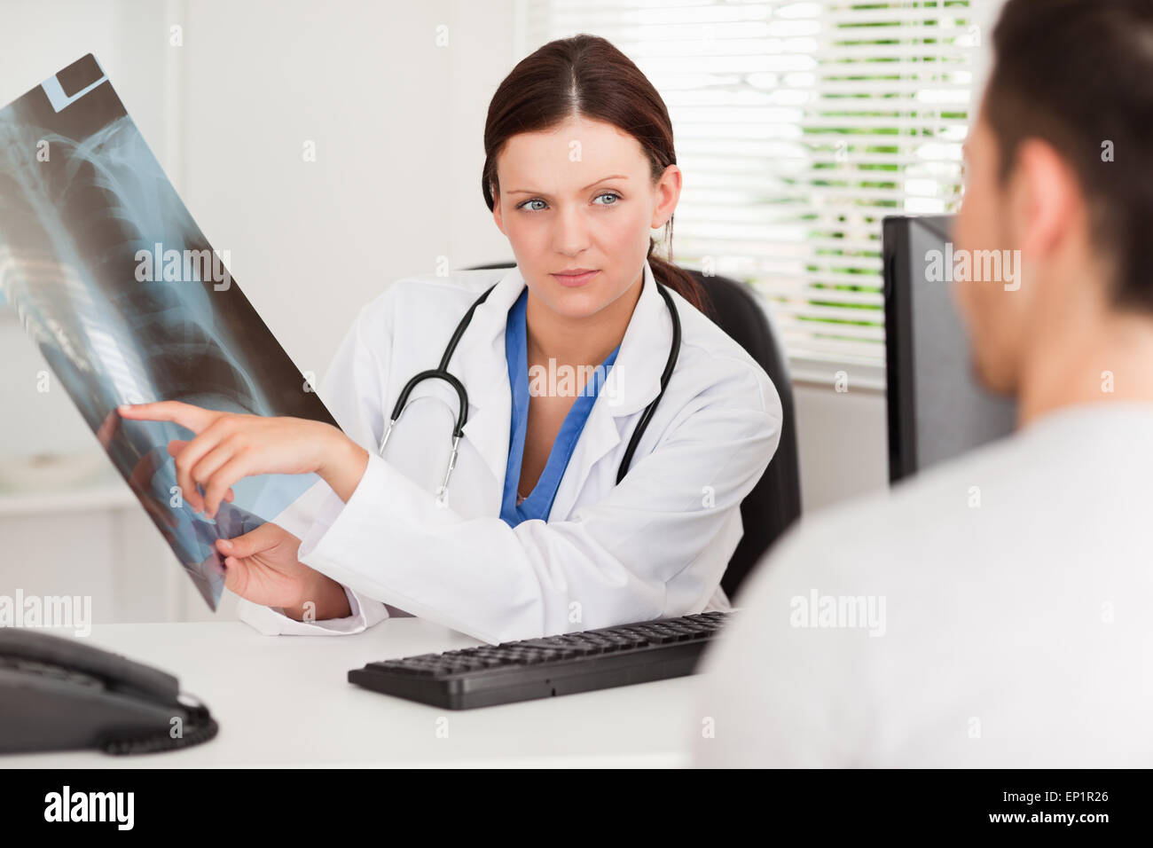 Female doctor showing patient x-ray Stock Photo - Alamy