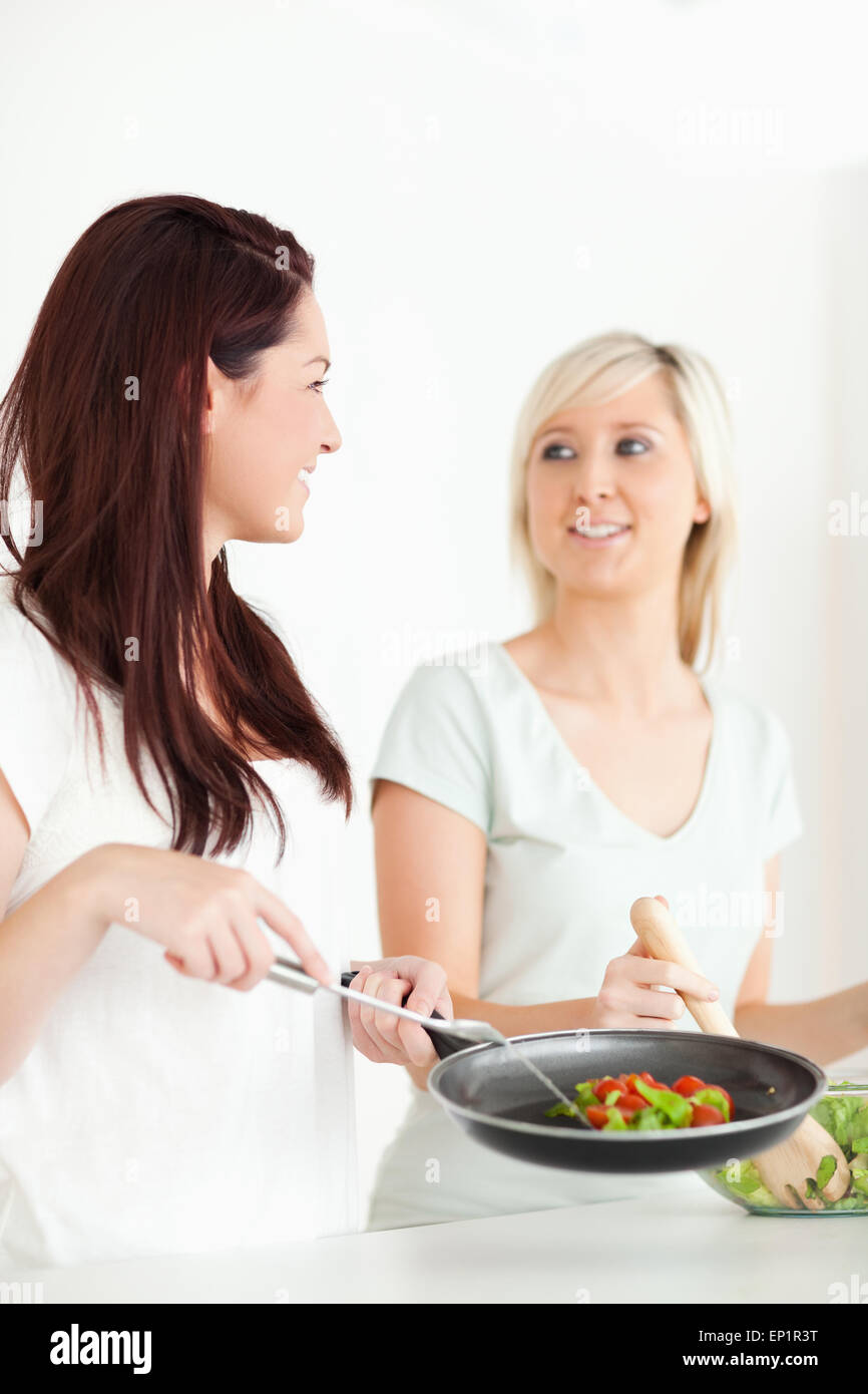 Cute Women cooking dinner Stock Photo - Alamy