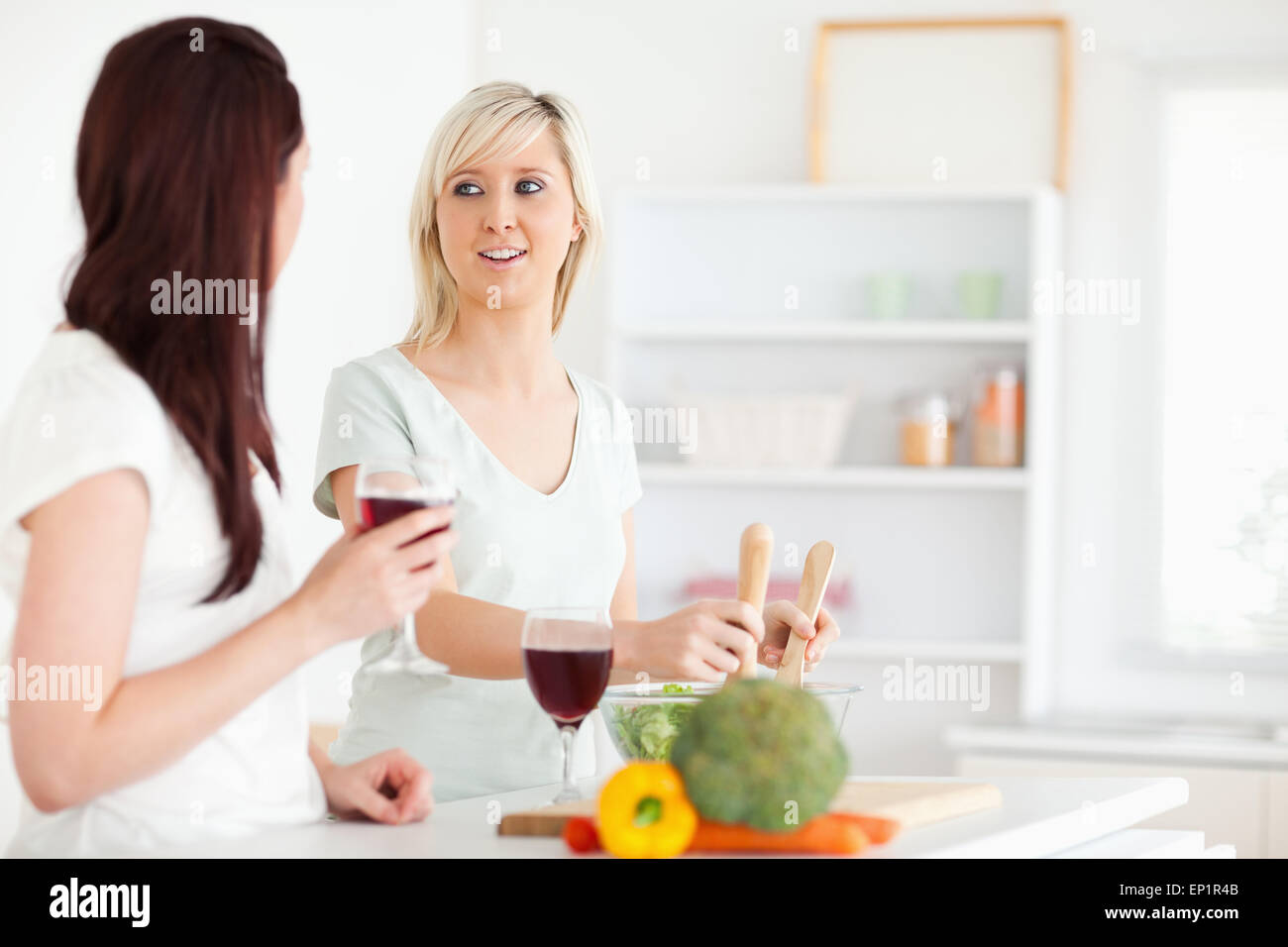 Laughing Women cooking dinner Stock Photo - Alamy