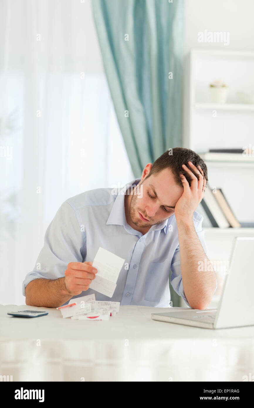 Concerned businessman looking at an invoice Stock Photo - Alamy