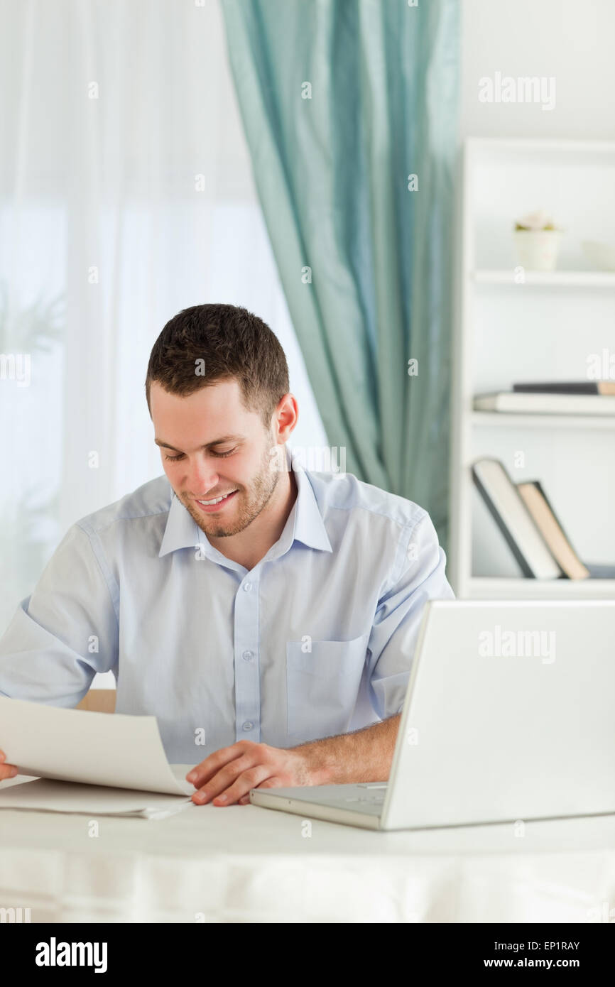 Smiling businessman reading a letter Stock Photo - Alamy