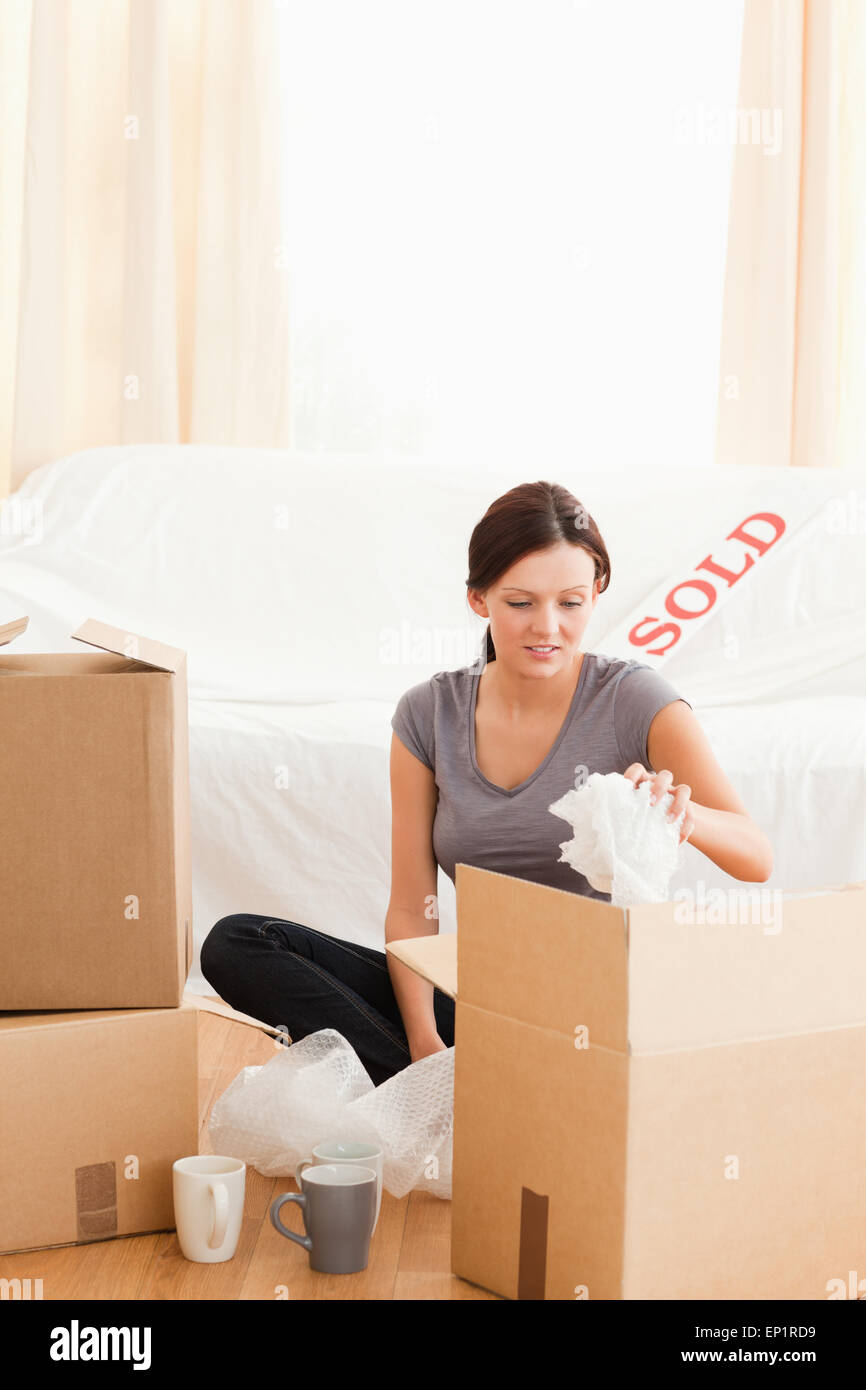 Cute woman packing her things Stock Photo - Alamy