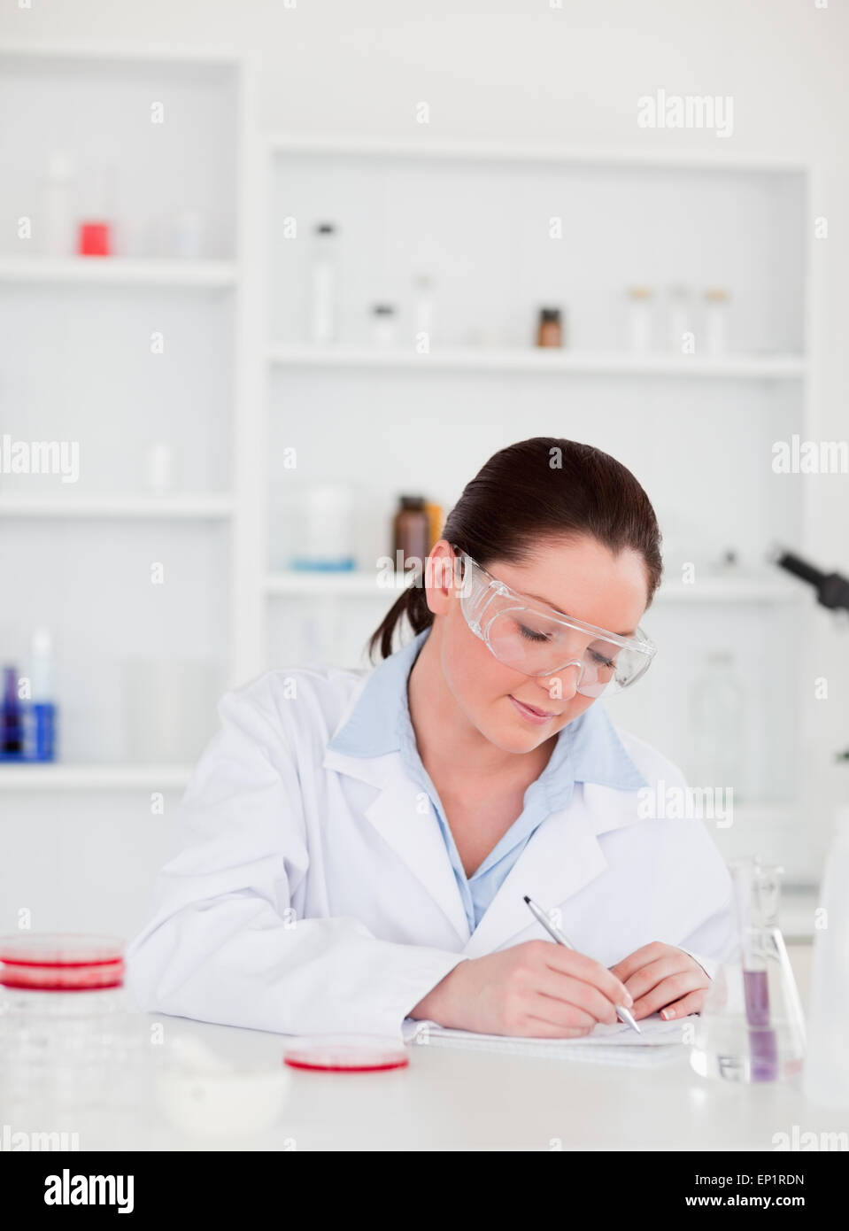 Portrait of a young scientist preparing a report Stock Photo - Alamy