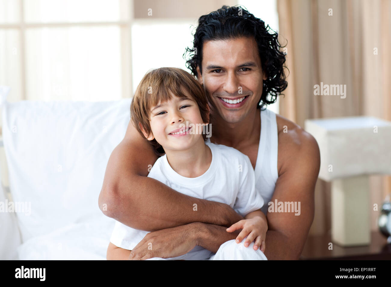 Caring father hugging his boy Stock Photo - Alamy