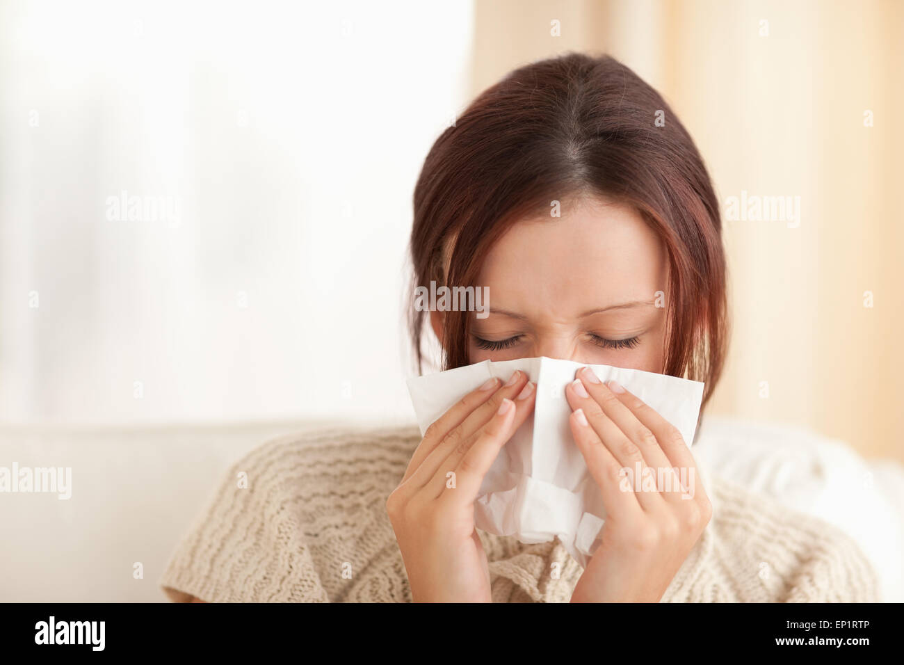 Sneezing cute woman Stock Photo - Alamy