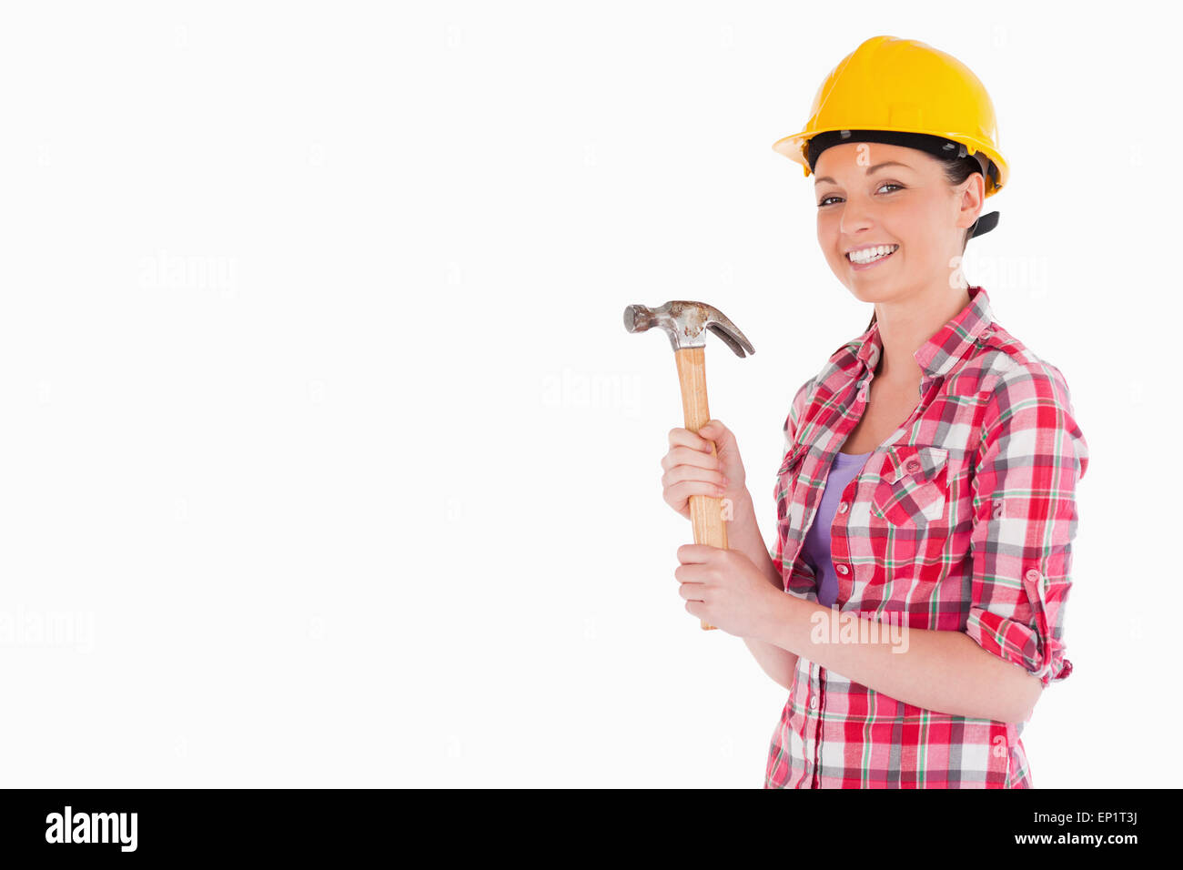 Attractive woman holding a hammer while standing Stock Photo - Alamy