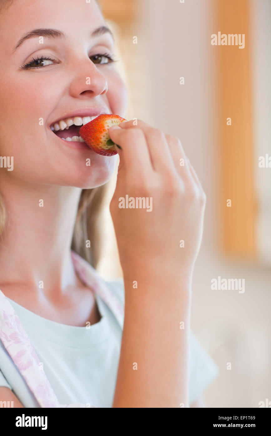 Close up of a woman eating a strawberry Stock Photo - Alamy